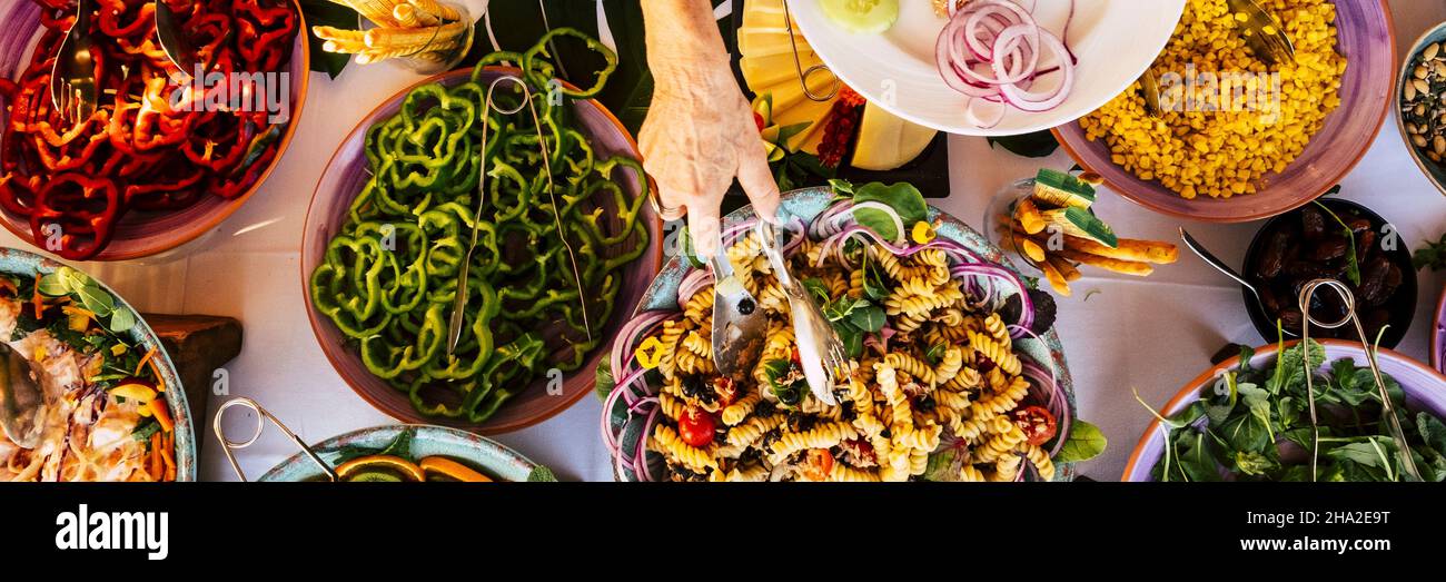 Above vertical banner header view of table full of food from catering ...