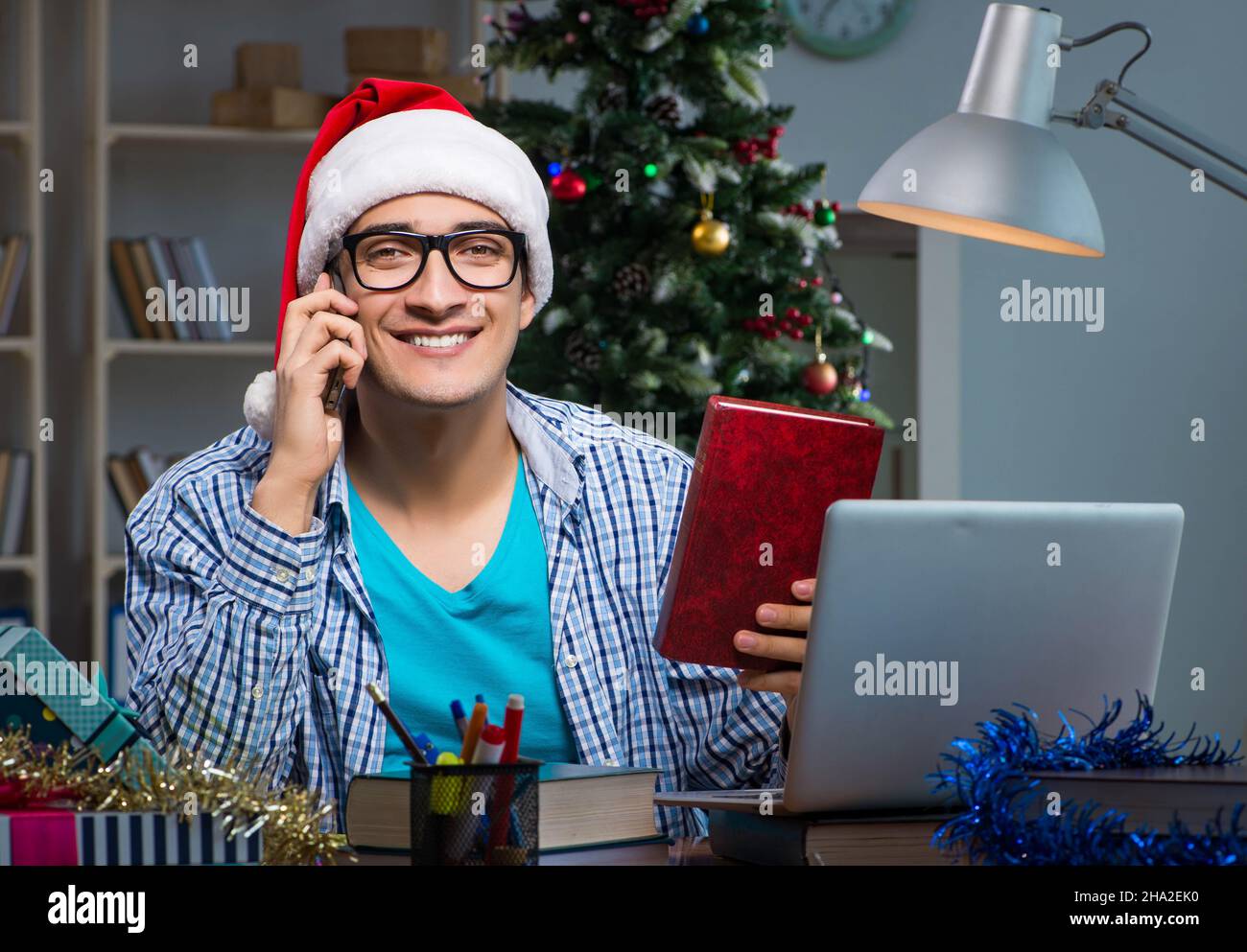 The young man working at home on christmas day Stock Photo - Alamy