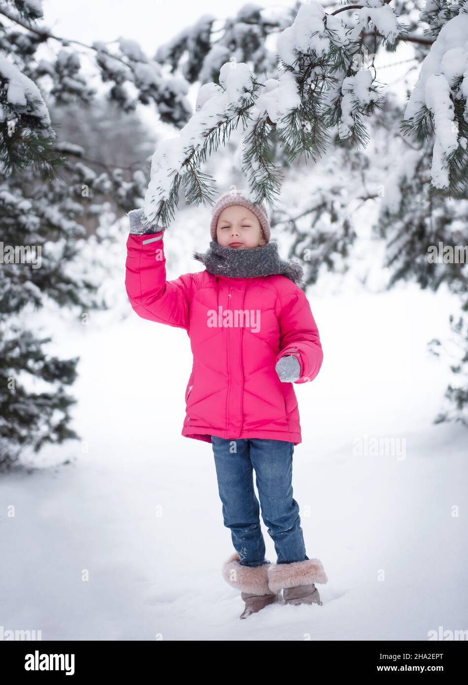 Child in winter. A little girl, playing in the winter outside. A ...
