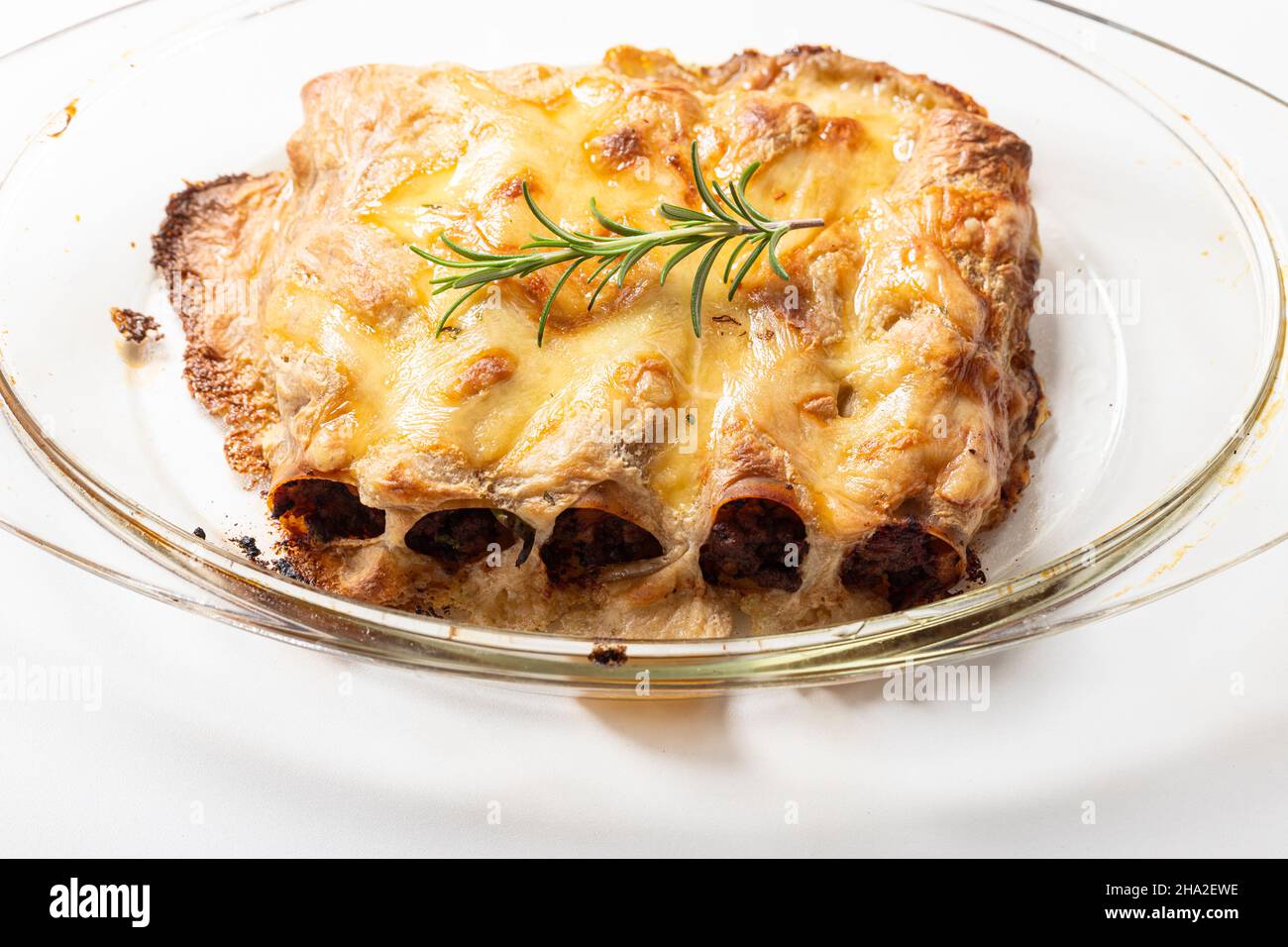 six italian canneloni pasta rolls on white Stock Photo - Alamy