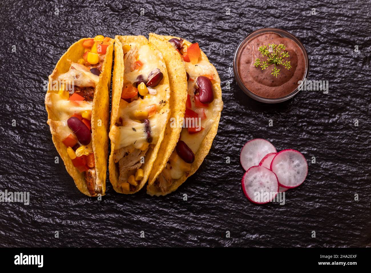 three mexican tacos on slate Stock Photo - Alamy