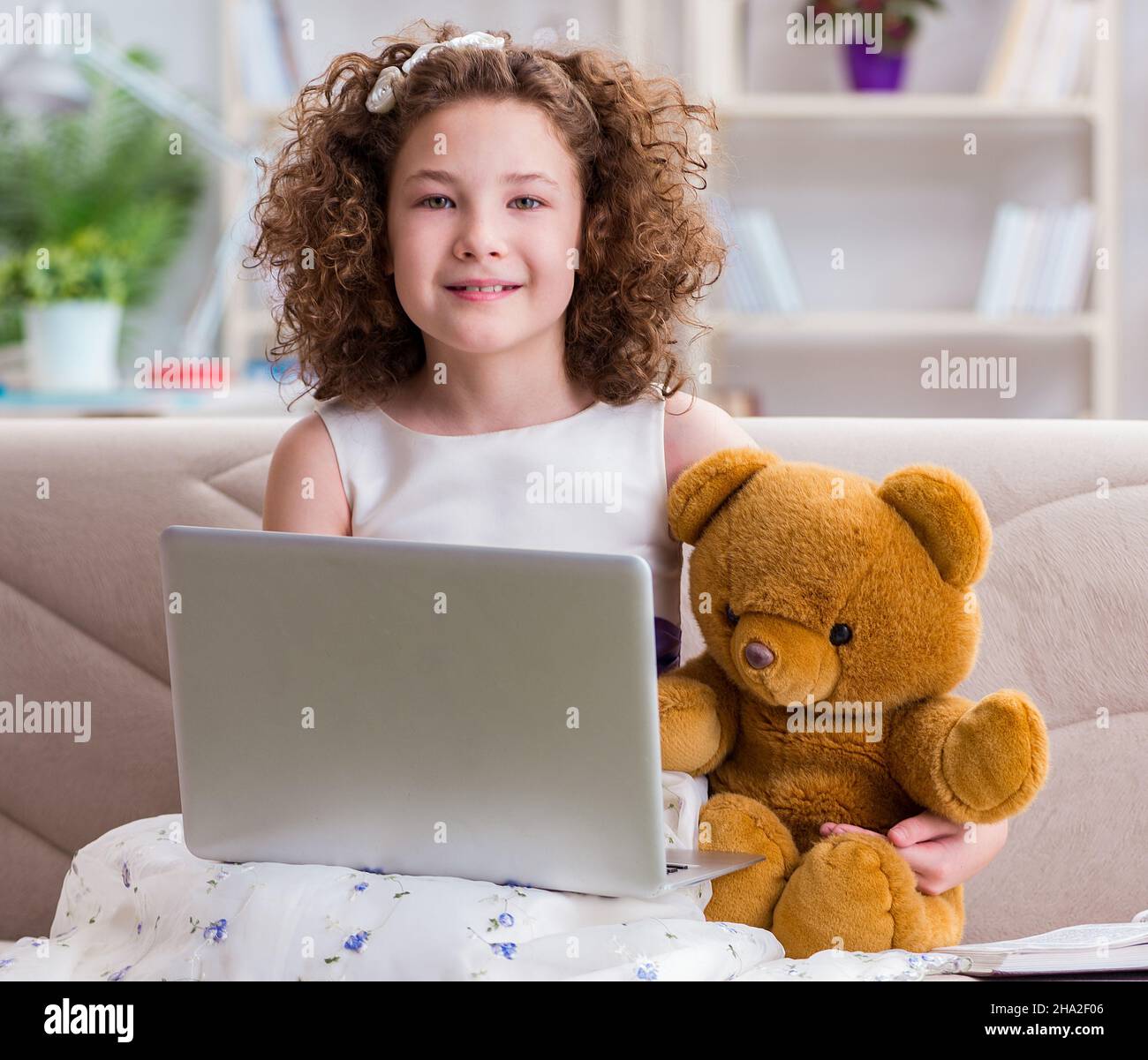 The little girl surfing internet on laptop Stock Photo - Alamy