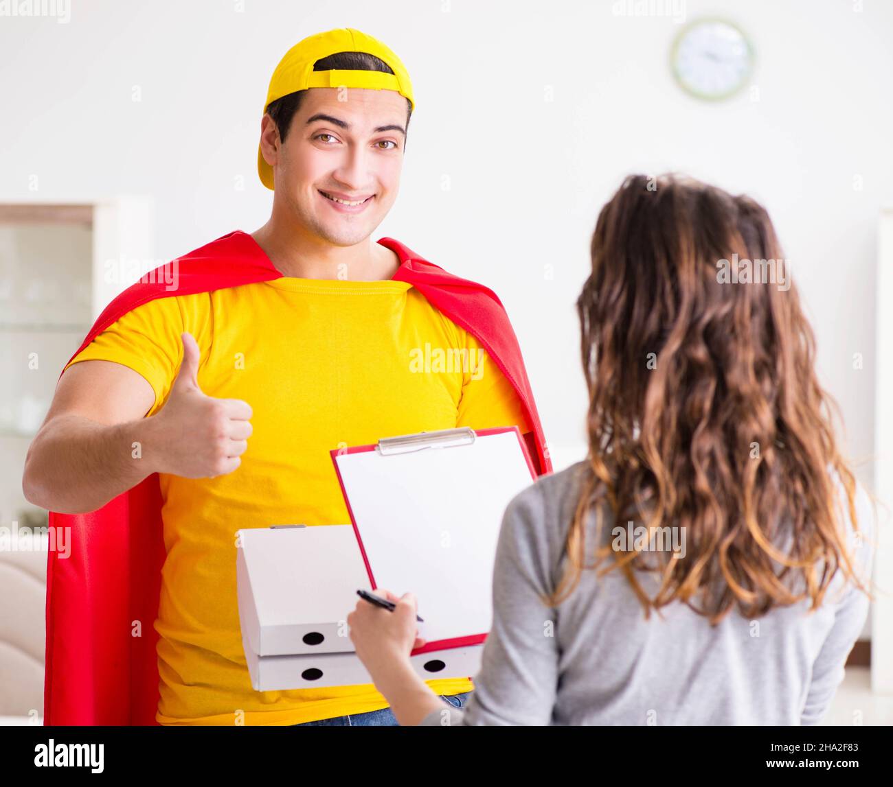 The superhero pizza delivery guy with red cover Stock Photo - Alamy