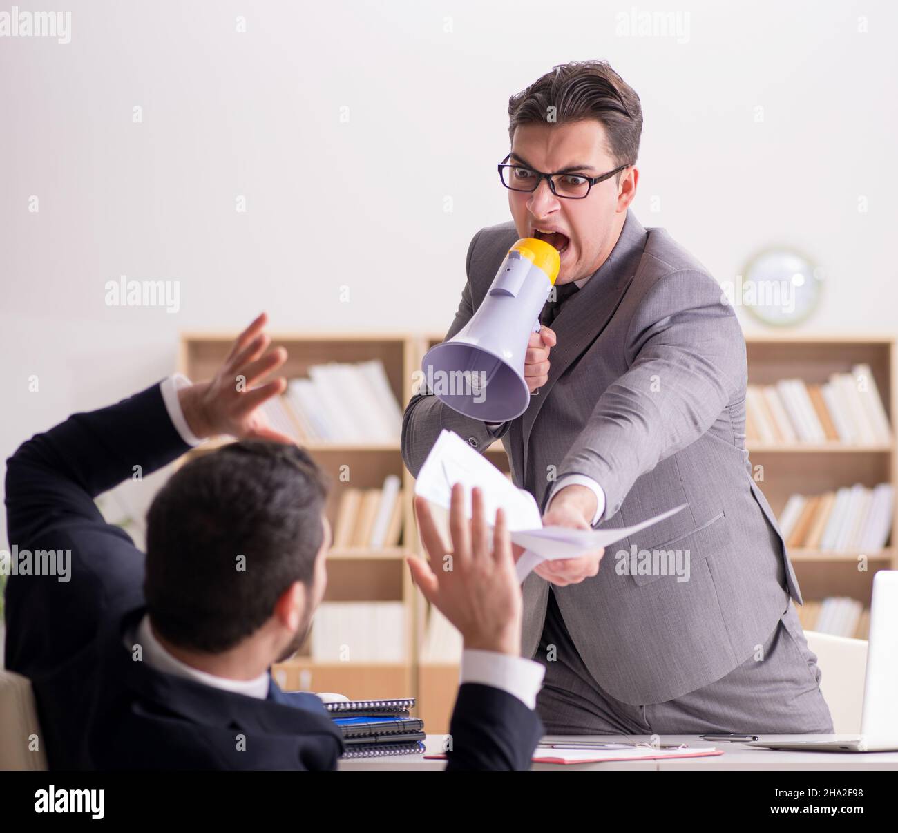 The angry boss shouting at his employee Stock Photo - Alamy