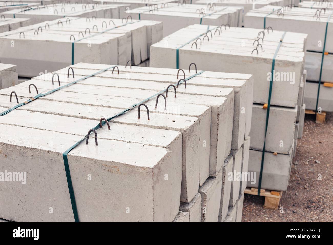 A lot of building cement blocks in an extensive open-air warehouse ...