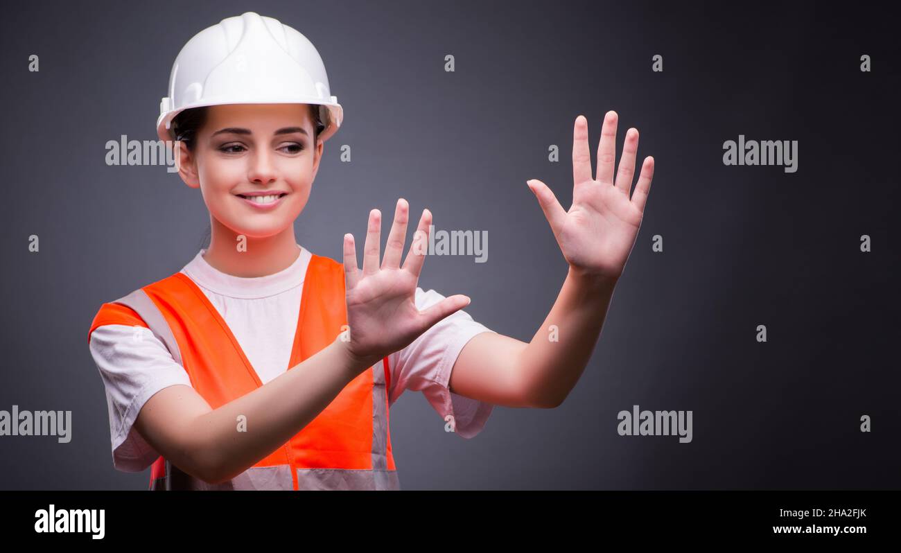 The cute construction worker pressing virtual buttons Stock Photo - Alamy