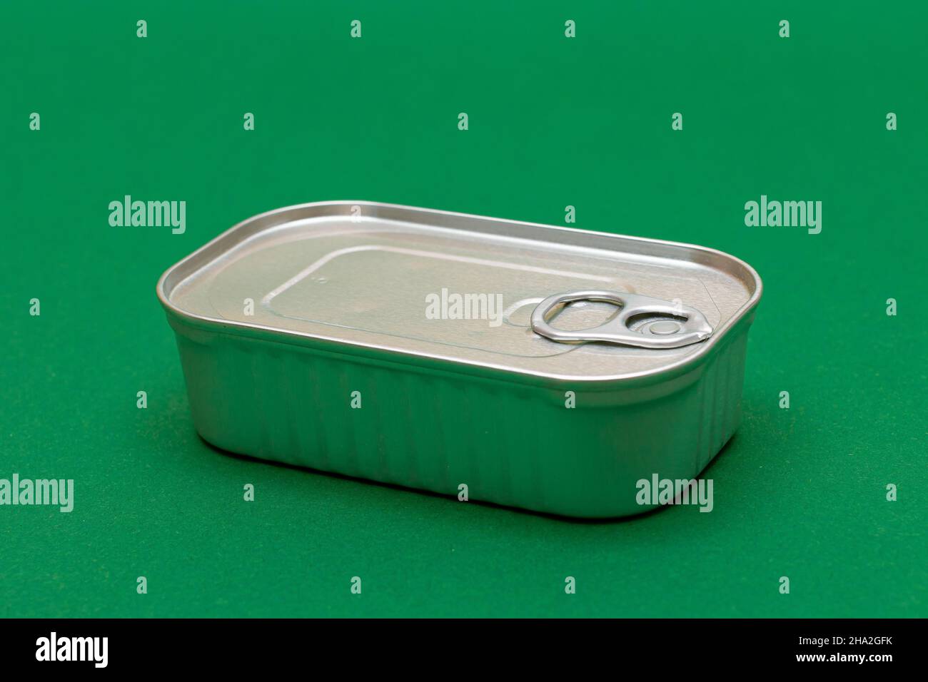 Unopened Tin Can with Blank Edge on Green Background. Canned Food ...
