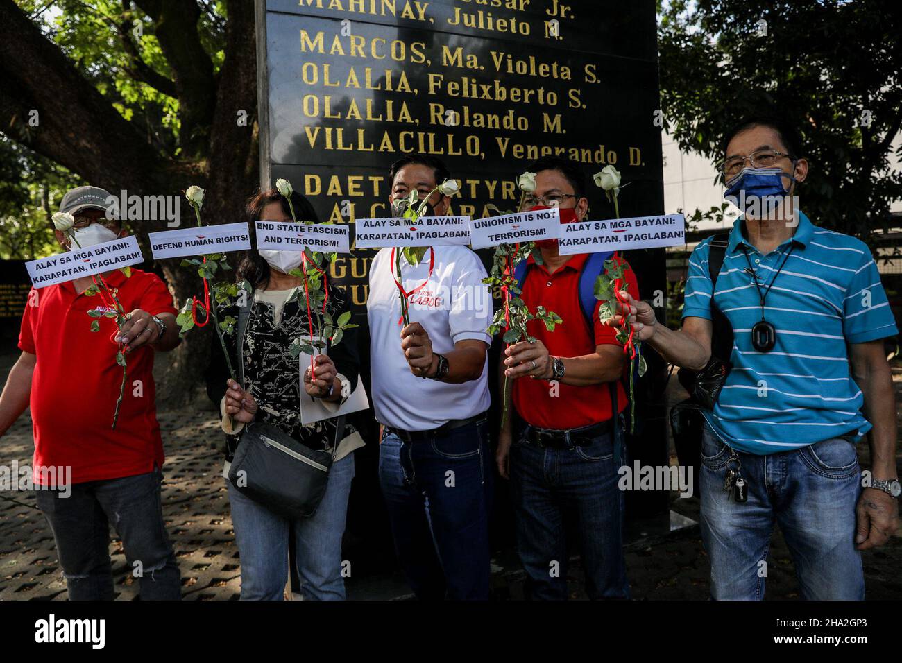 December 10, 2021: Human rights activists carry signs and offer flowers ...