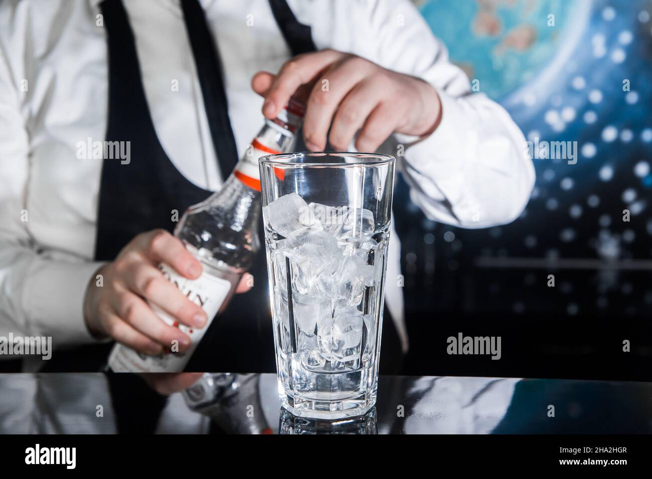The process of preparing a cocktail. Professional bartender with a ...