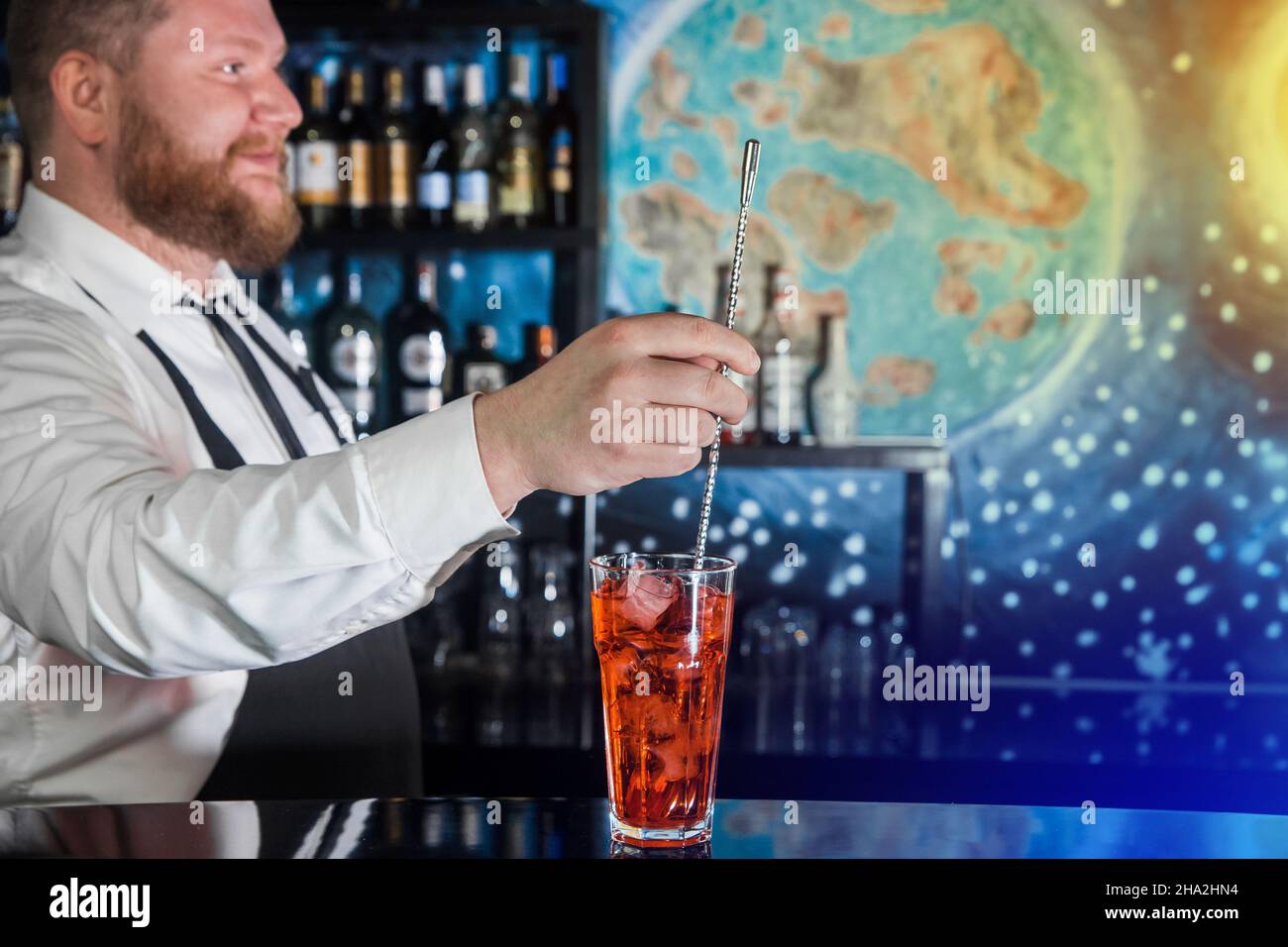 Adult bearded smiling bartender is professional and positive interferes ...
