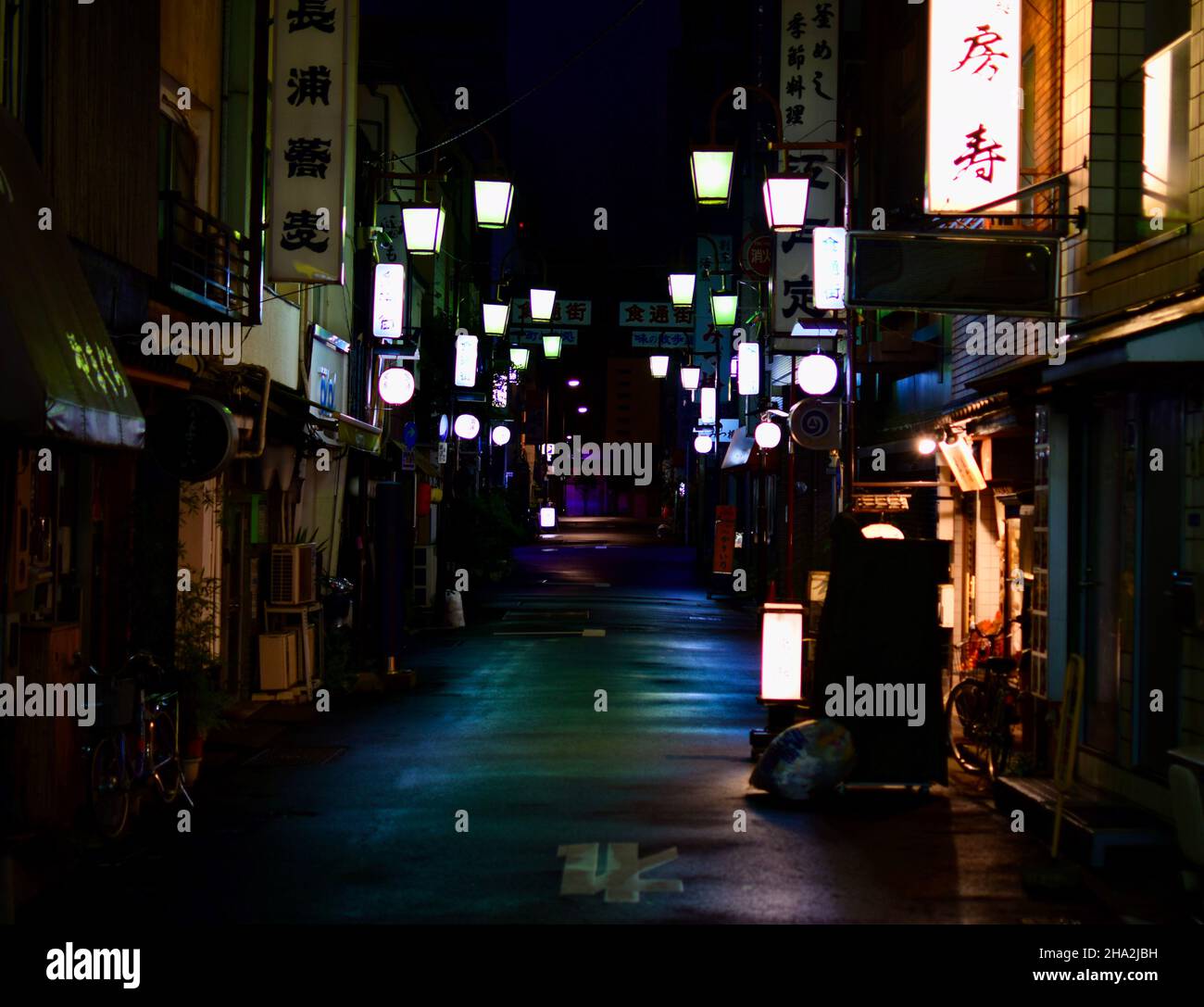 Street lit by colorful street lights Stock Photo - Alamy