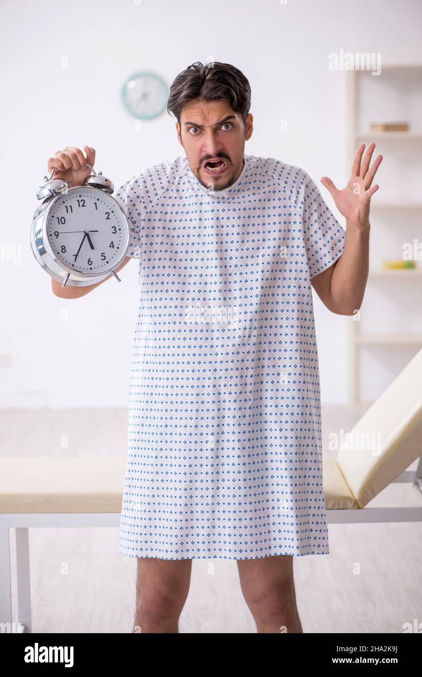 Young patient in time management concept Stock Photo - Alamy