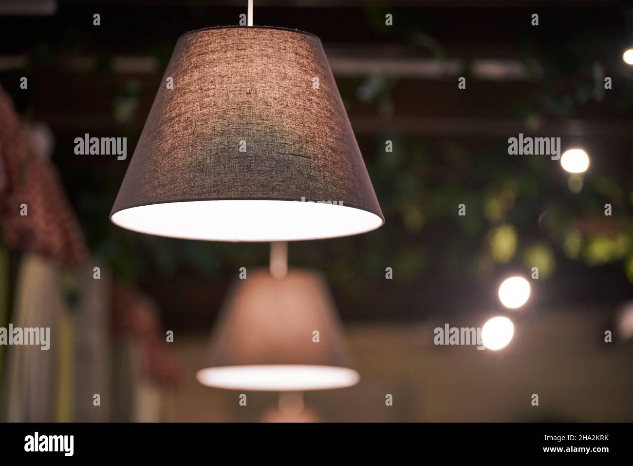 Pendant lamps over tables in city cafe, evening lighting restaurant ...