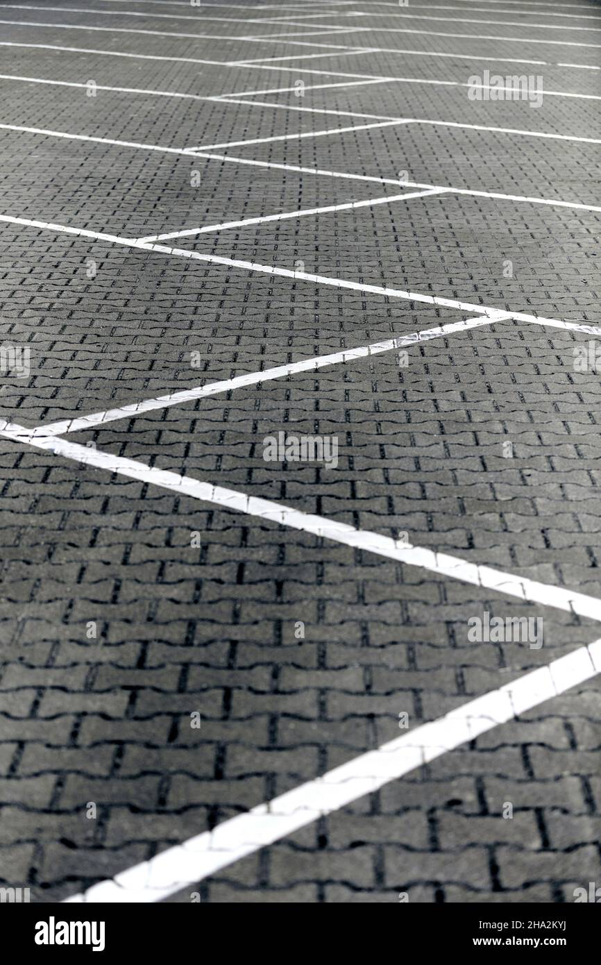 Parking road marking on brick pavement without cars. White road surface ...