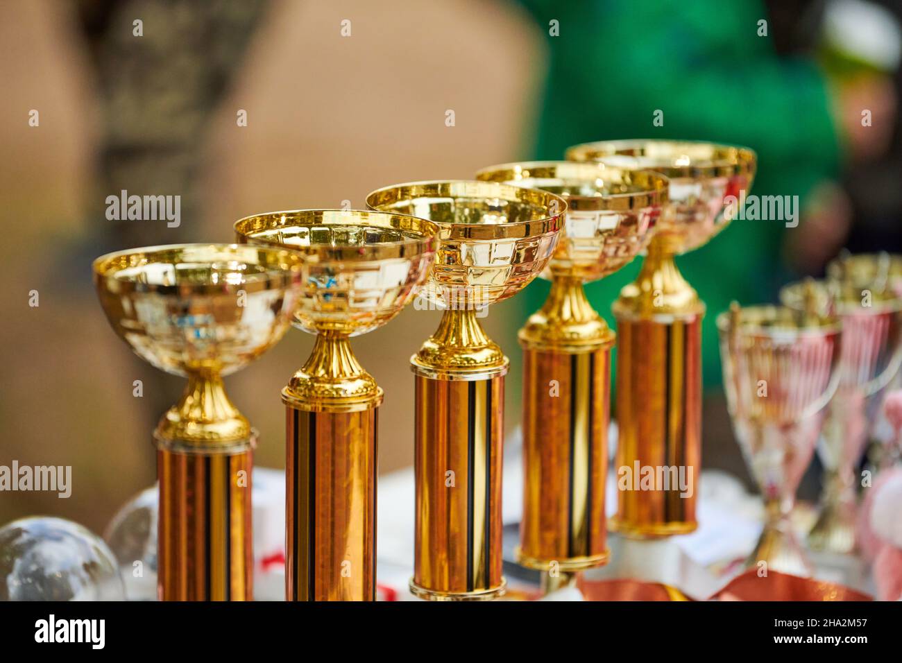 Champion golden trophies in row close up, selective focus. Many shiny ...