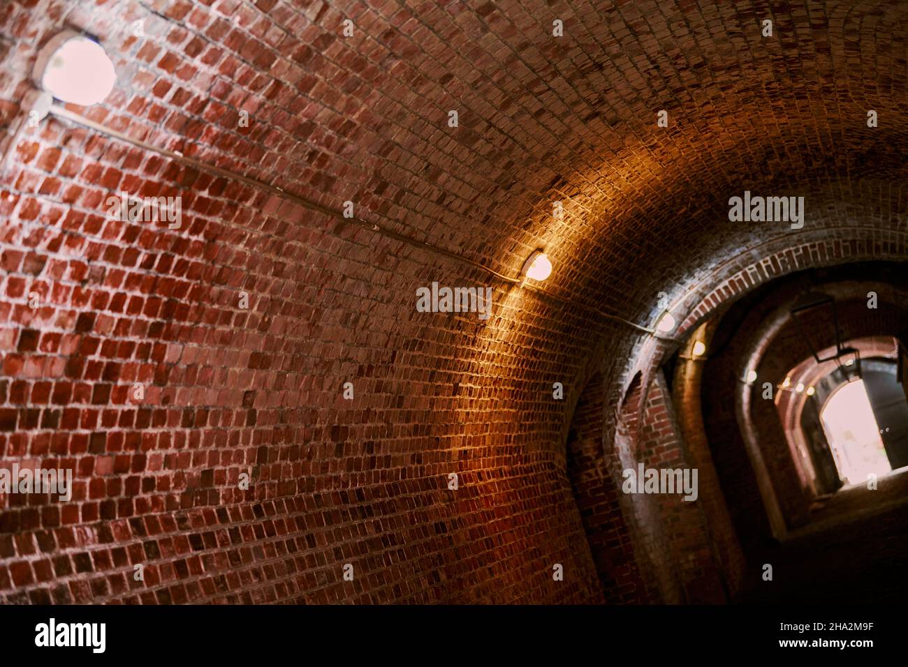 Brick tunnel in old German fort, red brick loft corridor with old ...
