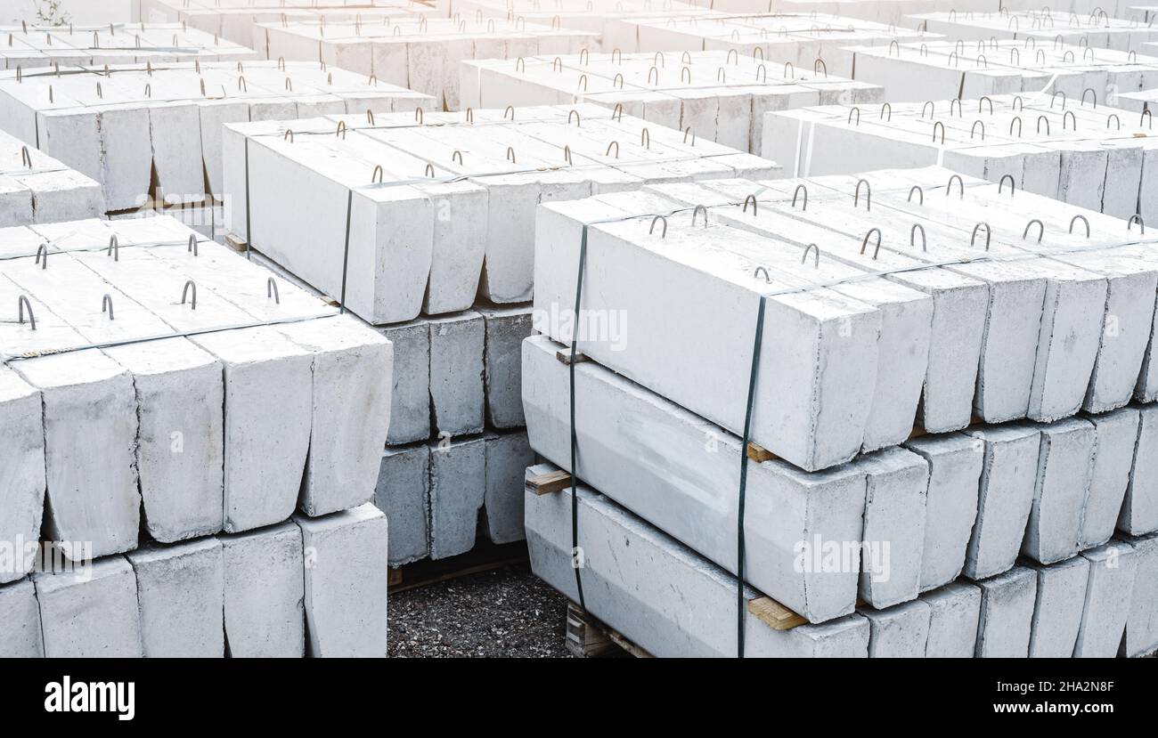 A lot of building cement blocks in an extensive open-air warehouse ...