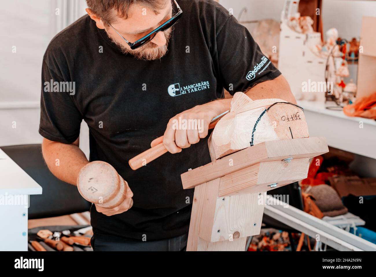 06 July 2021, Ufa, Russia: Craftsman artist and carpenter cutting ...