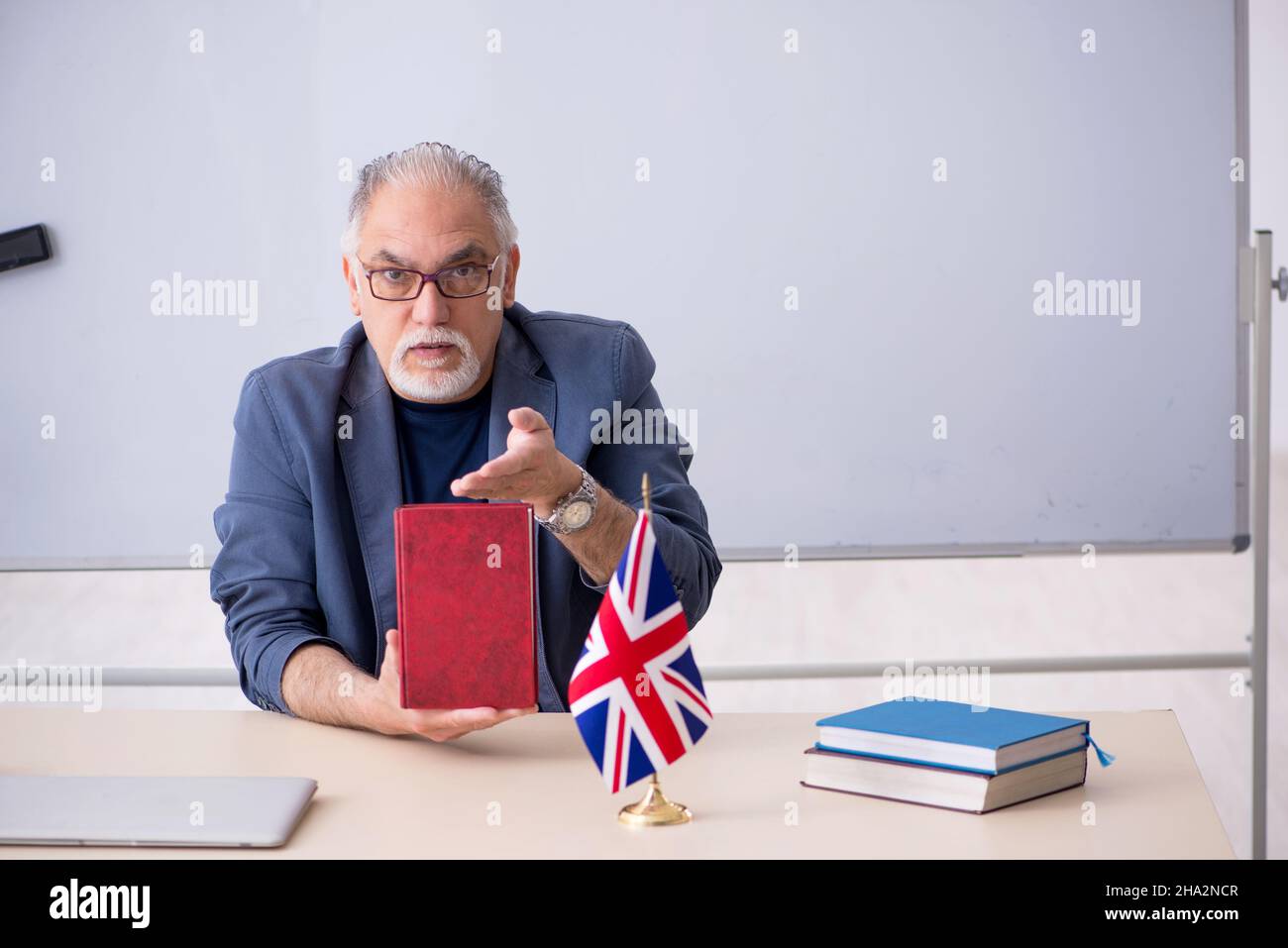 Old english language teacher in the classroom Stock Photo - Alamy