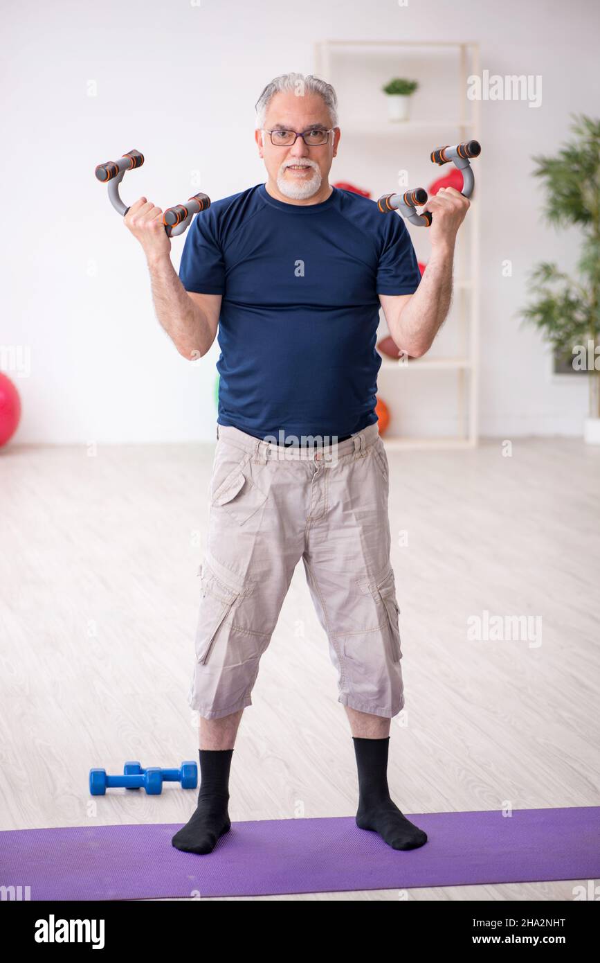 Old man doing sport exercises at home Stock Photo - Alamy