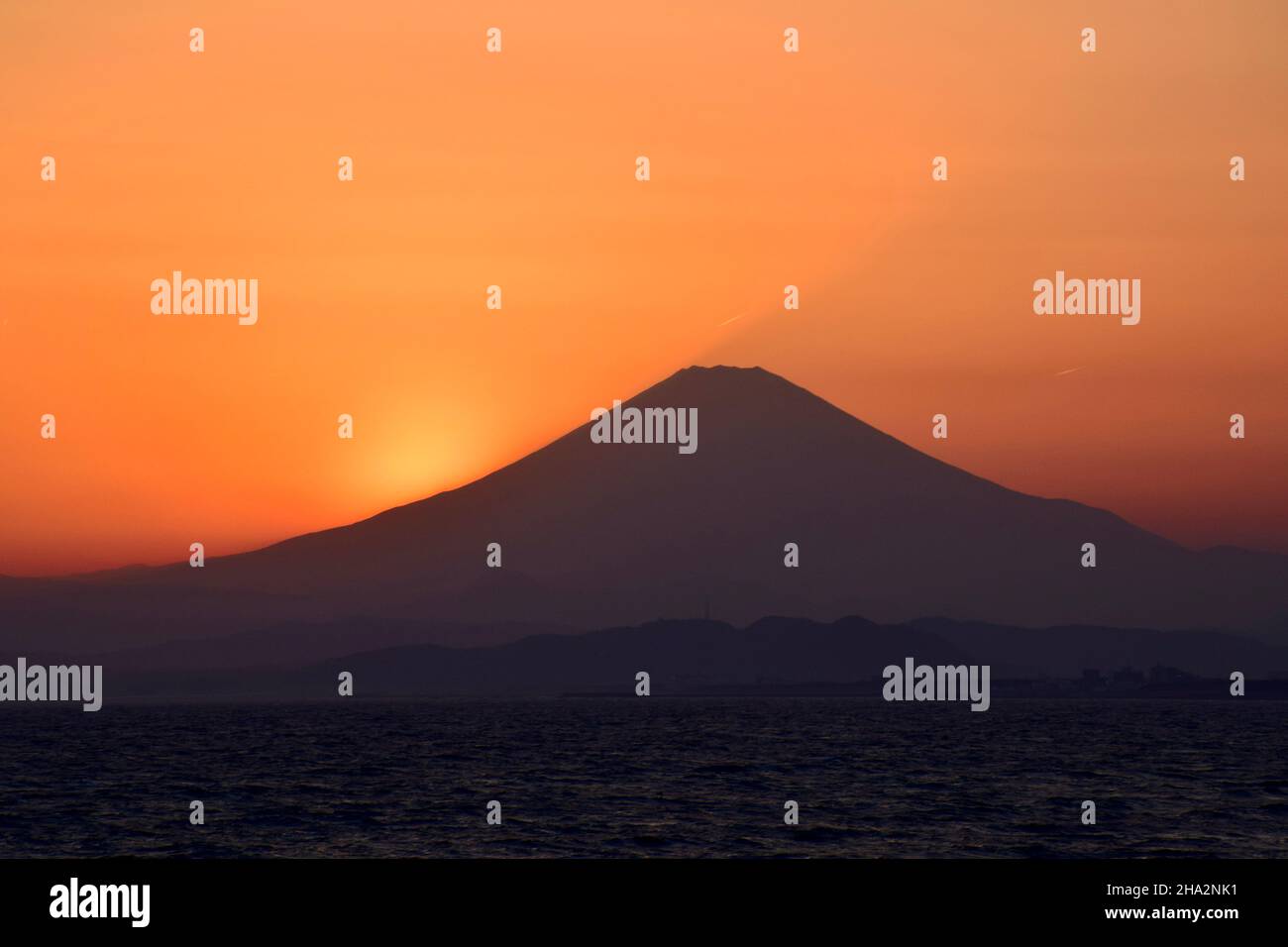 Mt. Fuji over the sea at sunset Stock Photo - Alamy