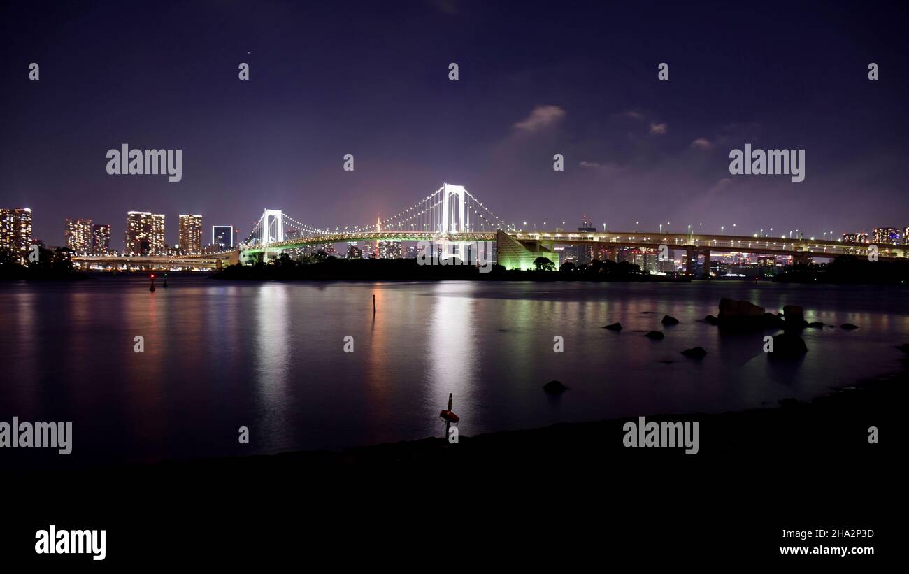 Rainbow bridge at night in front of the Tokyo skyline Stock Photo - Alamy
