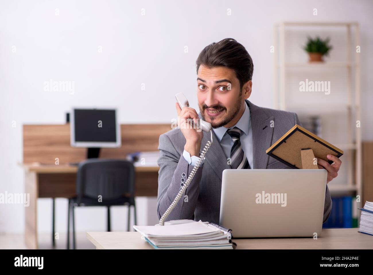Young businessman employee missing girlfriend at workplace Stock Photo ...