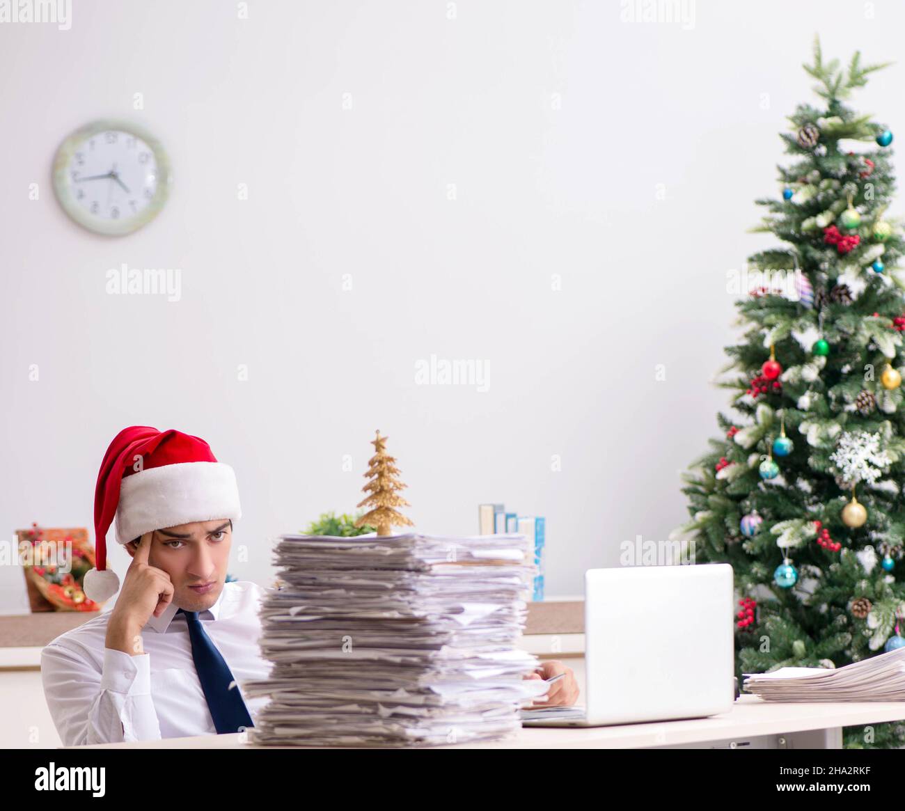 The young worker working in office on christmas shift Stock Photo - Alamy