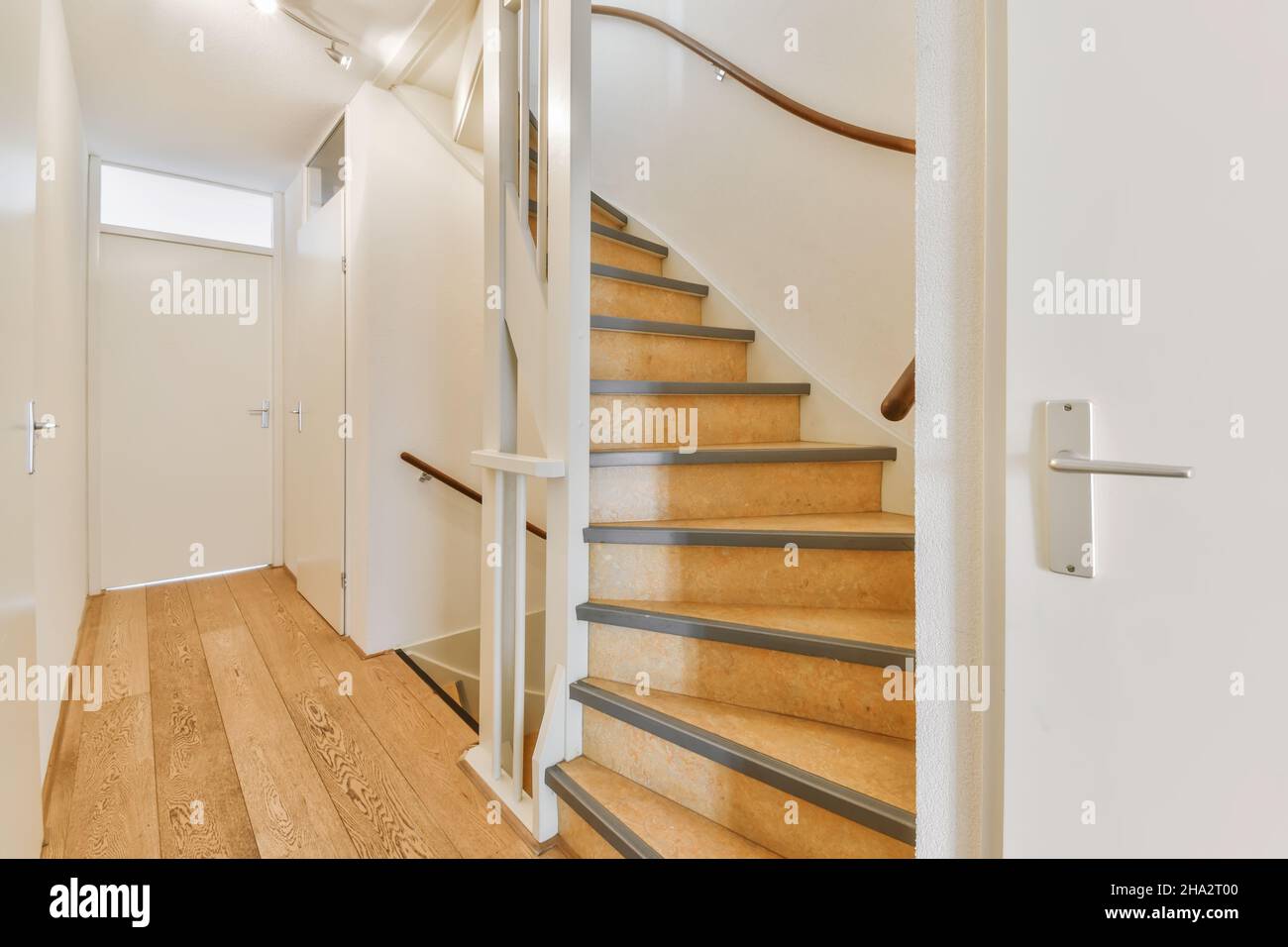 Lovely corridor with wooden floor and spiral staircase Stock Photo - Alamy