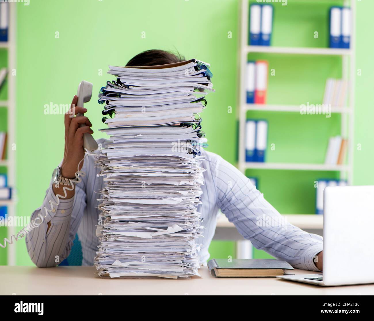 The businessman having problems with paperwork and workload Stock Photo ...