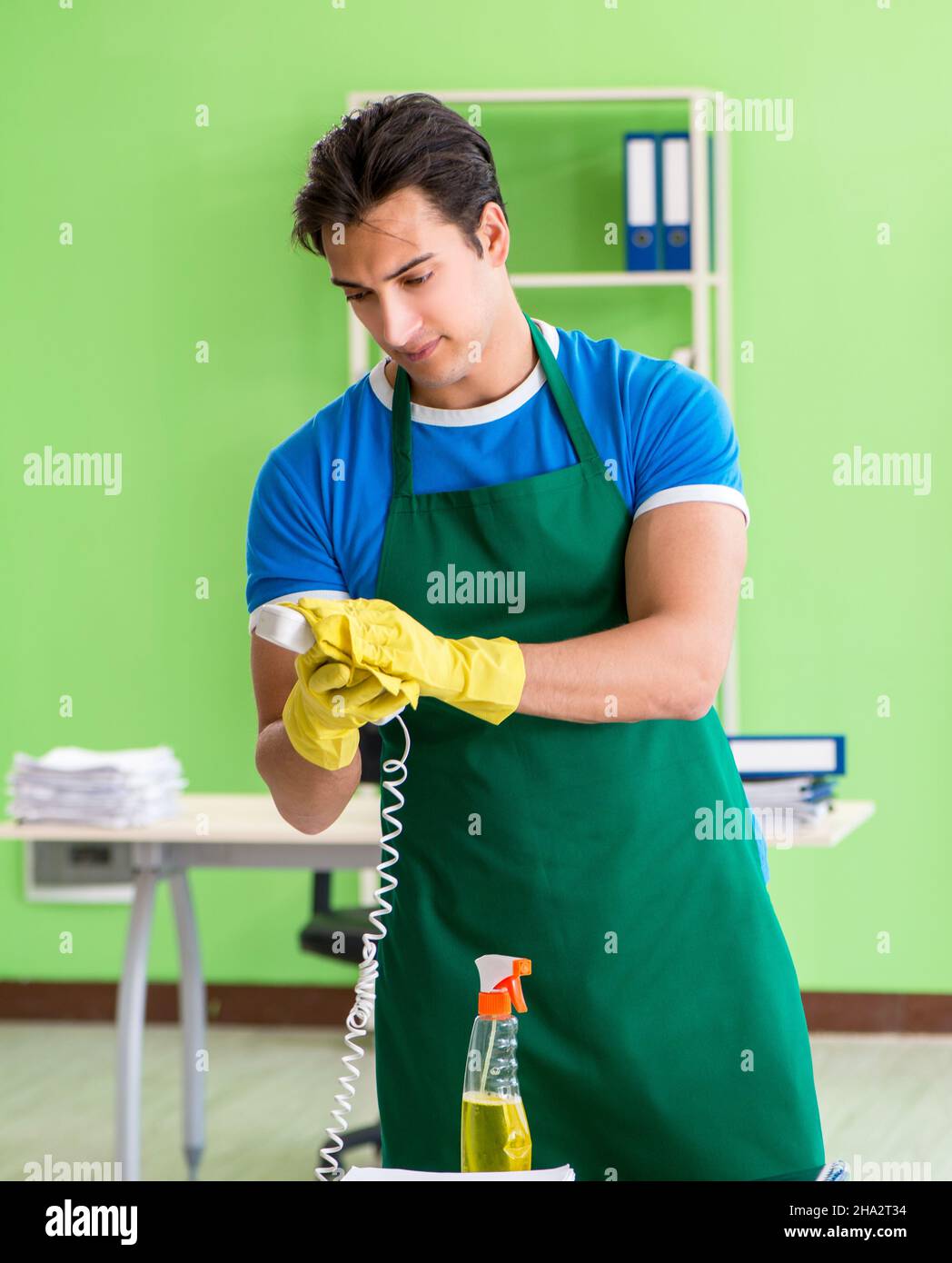 The male handsome professional cleaner working in the office Stock ...