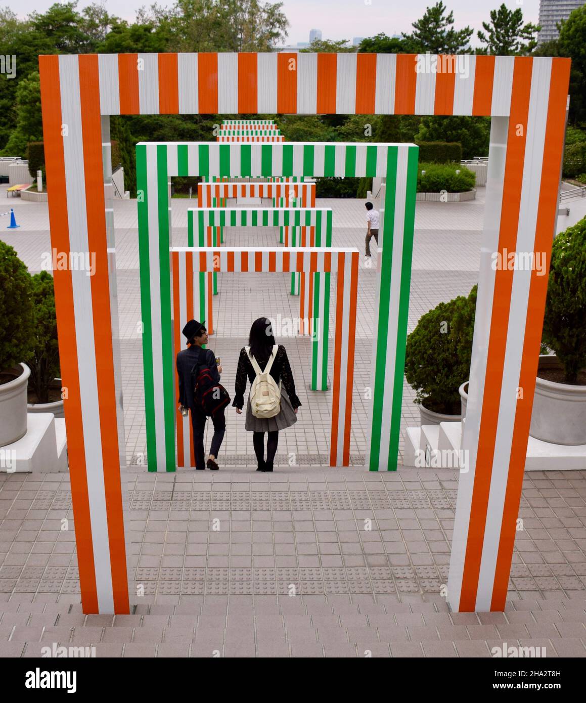 Rear view of couple walking through gates Stock Photo - Alamy