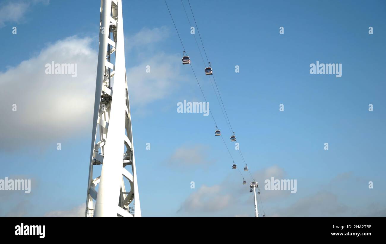 Modern cable car with cabins on blue sky background. Action. Beautiful ...