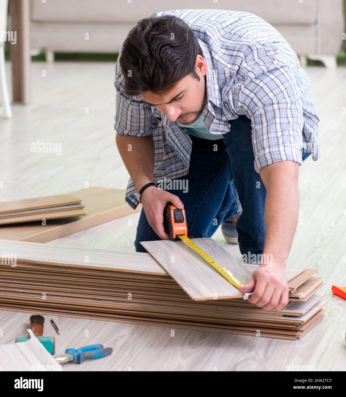 The man laying flooring at home Stock Photo - Alamy