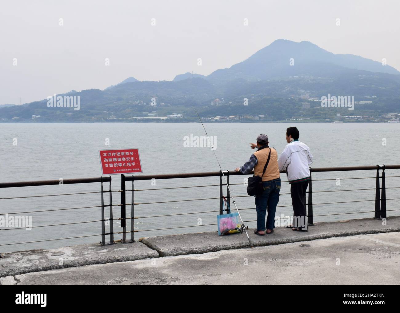 Men fishing over the bay in Taiwan Stock Photo - Alamy