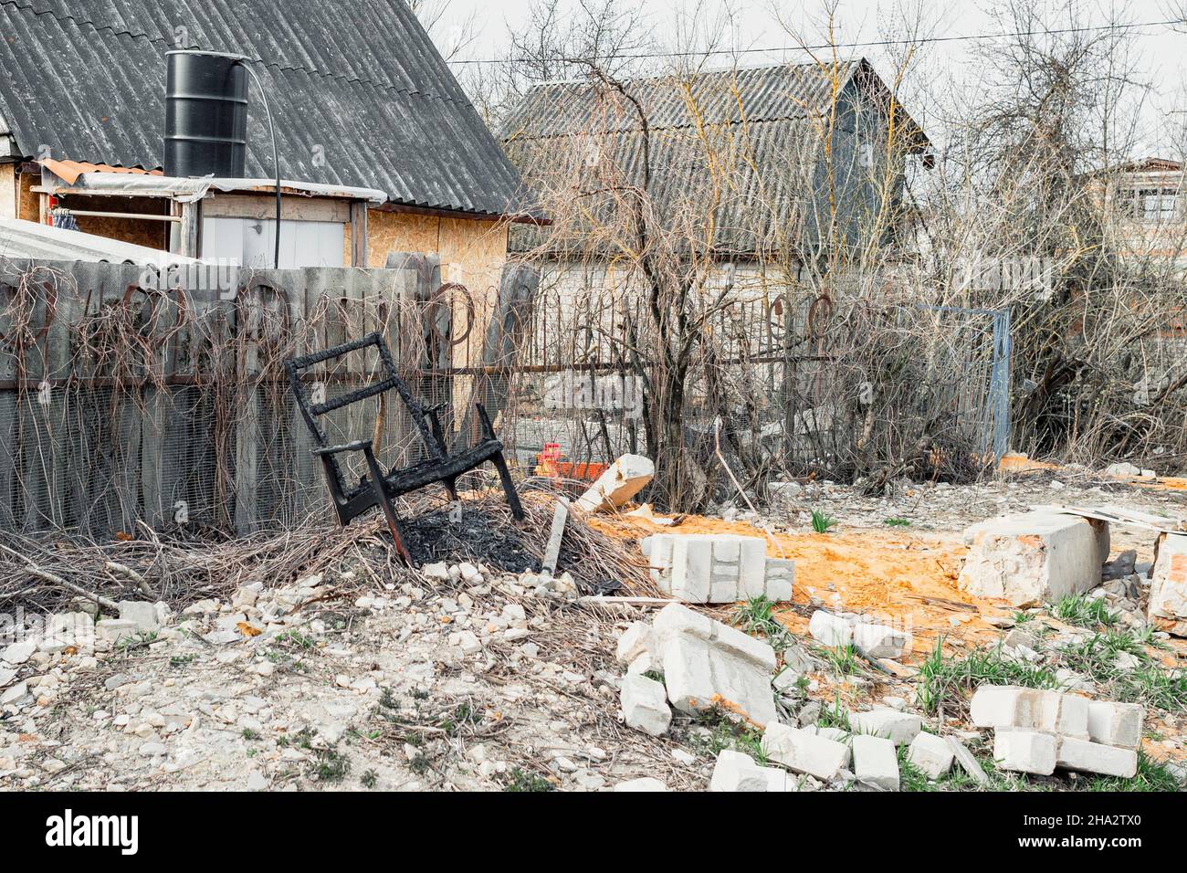 Burnt chair, similar to the throne, standing on a pile of construction ...