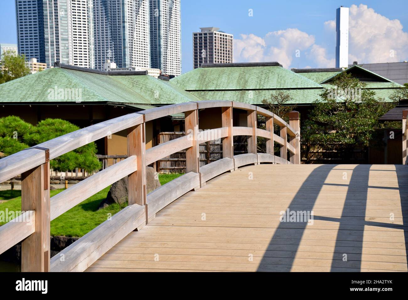 View of buildings and clouds in a city over a foot bridge Stock Photo ...