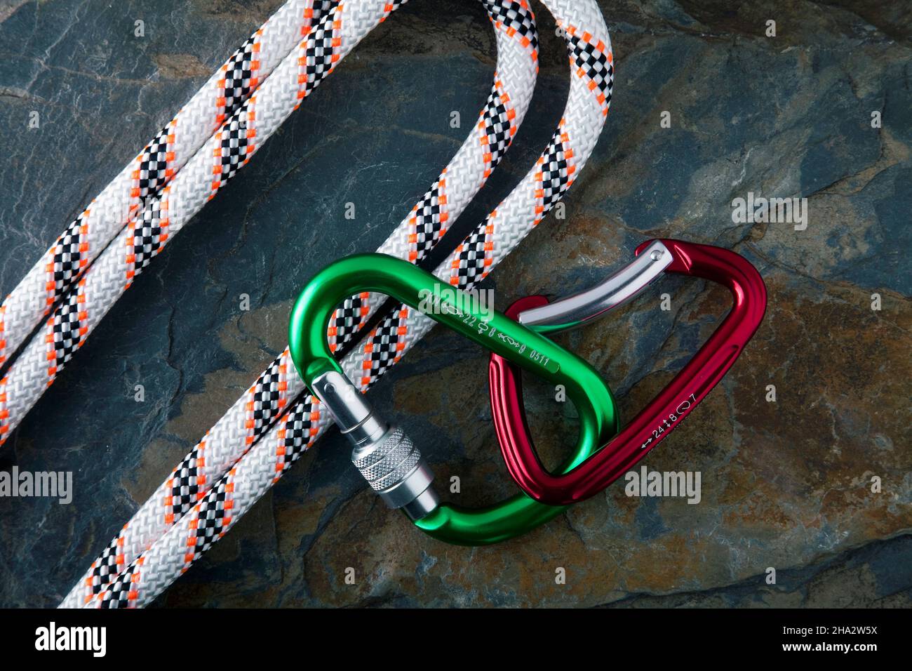 two carabiners with rope on a stone surface Stock Photo - Alamy