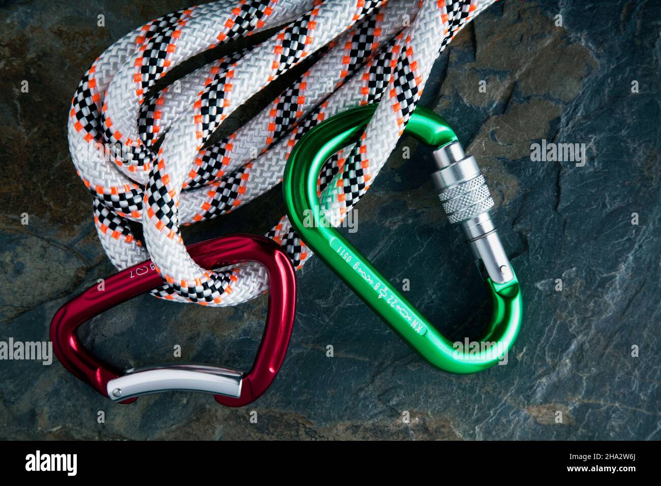 two carabiners with rope on a stone surface Stock Photo - Alamy