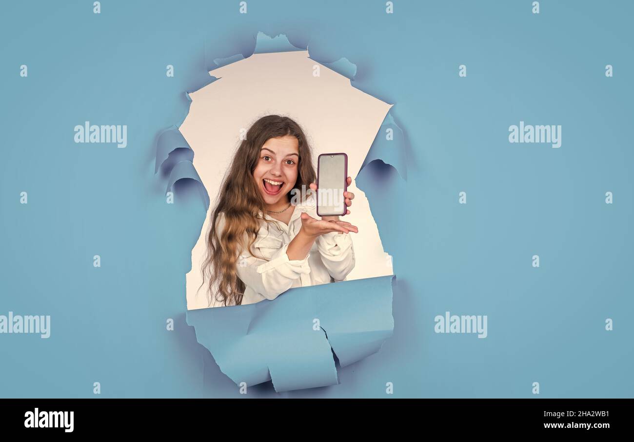 look over there. smiling child with mobile phone. childhood happiness ...