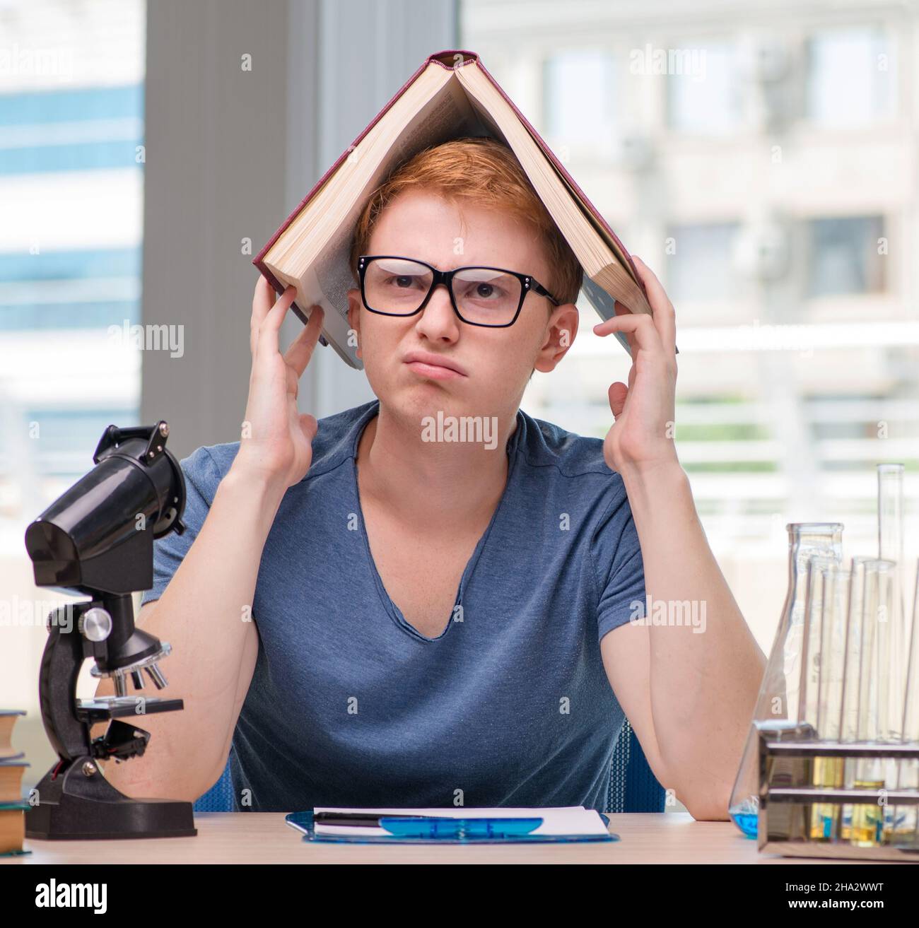 The young student tired and exhausted preparing for chemistry exam ...