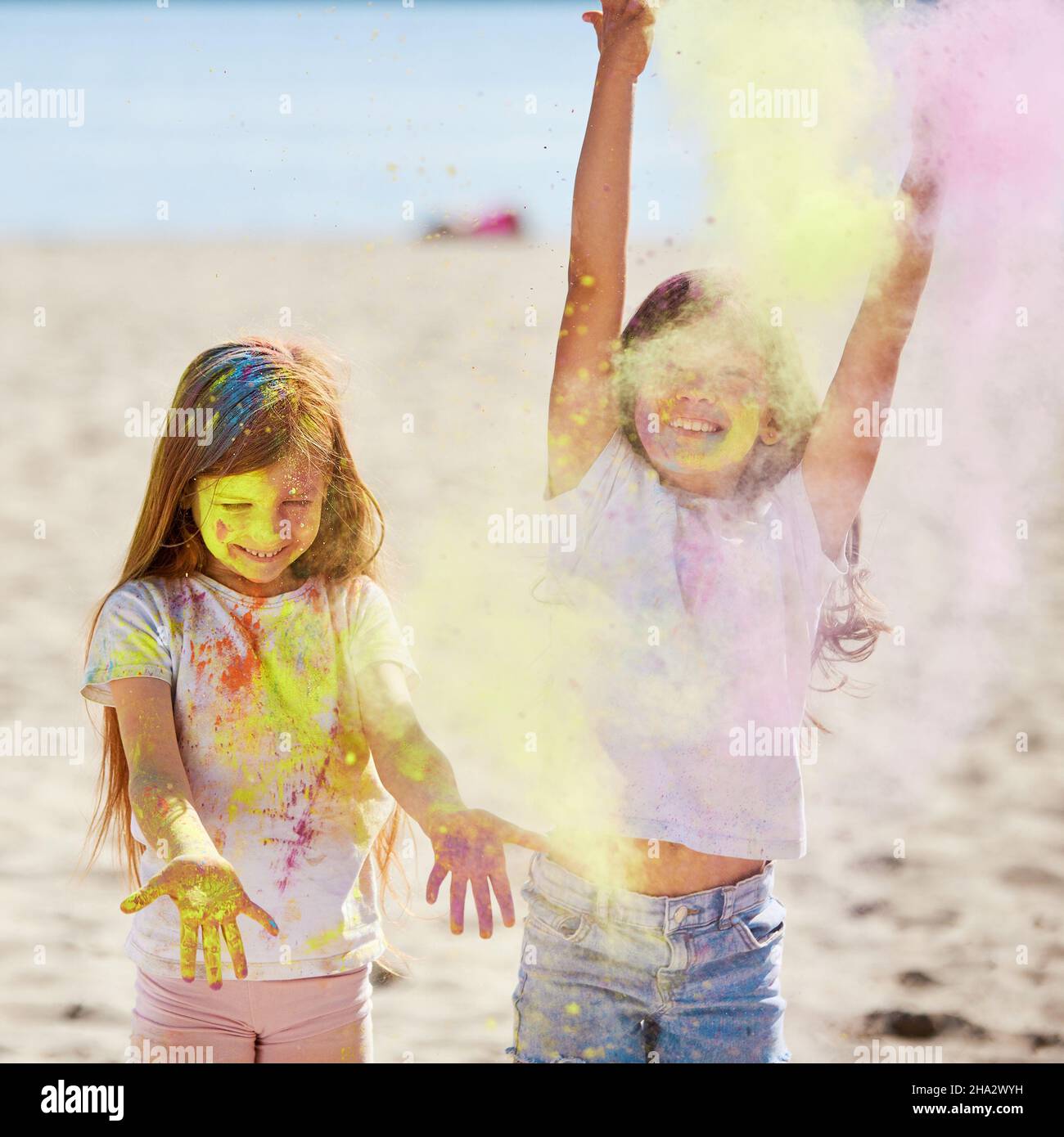 happy children throw bright paints and smiling Stock Photo - Alamy