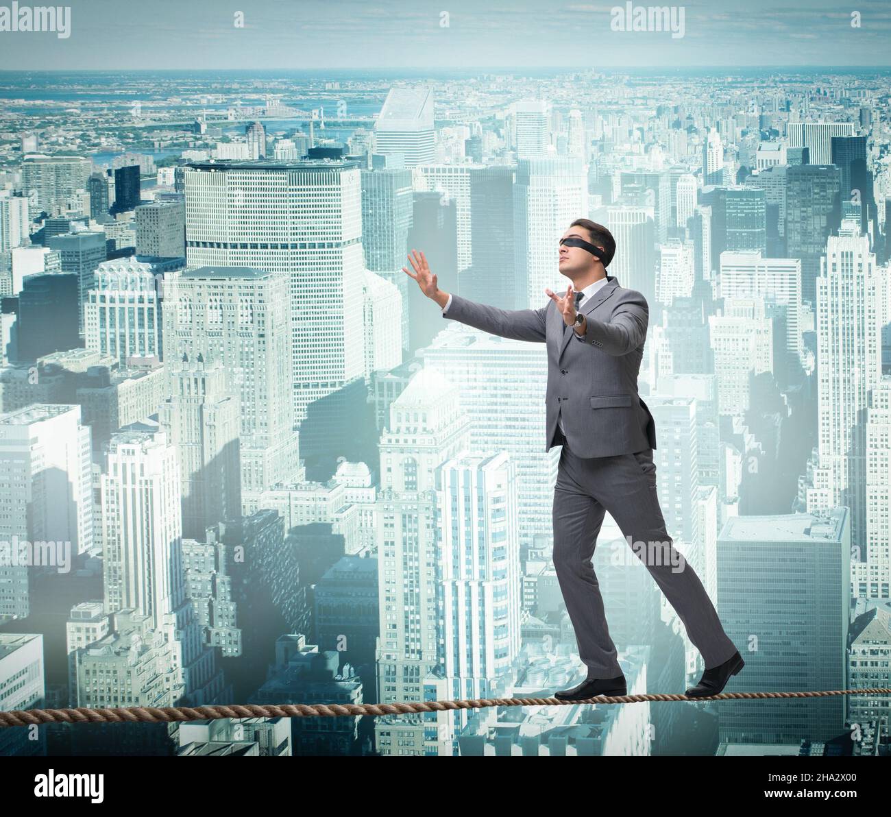 The man walking in tight rope blindfold Stock Photo - Alamy