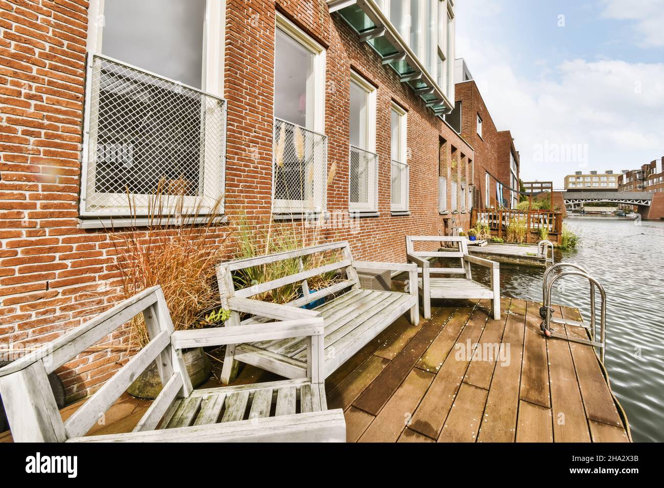 Adorable wooden boathouse in front of brick houses Stock Photo - Alamy