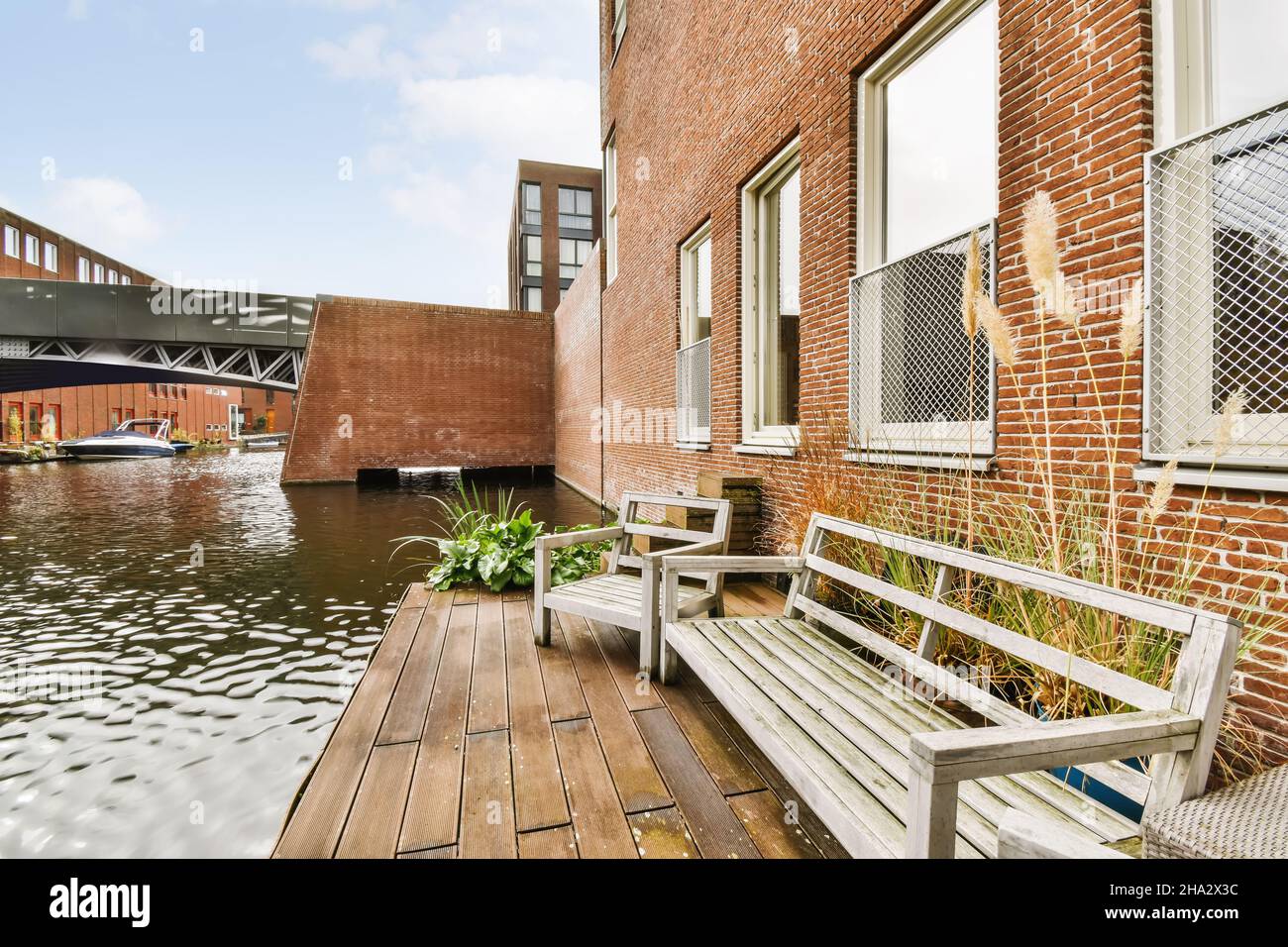 Adorable wooden boathouse in front of brick houses Stock Photo - Alamy
