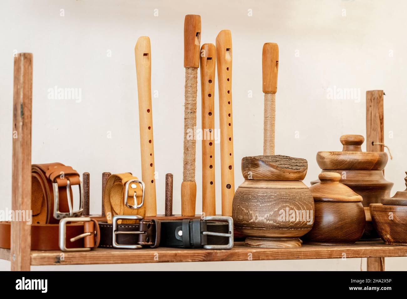 Handmade stall selling wooden flutes and leather belts Stock Photo - Alamy