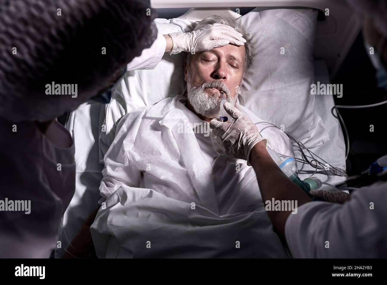 Two doctors caring of sick patient in resuscitation at night time ...