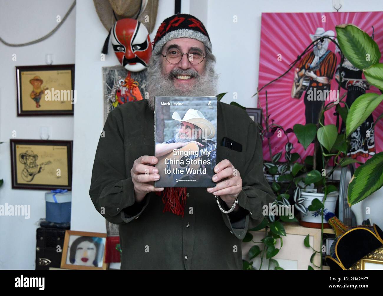 Beijing, China. 22nd Nov, 2021. Mark Levine shows a book written by ...