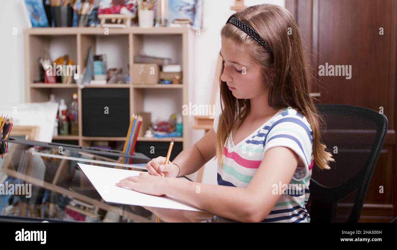 Children painter drawing creative sketch on paper using graphic pencil ...