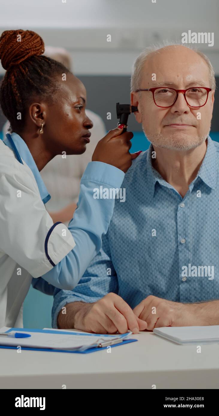 African american doctor using otoscope hi-res stock photography and ...